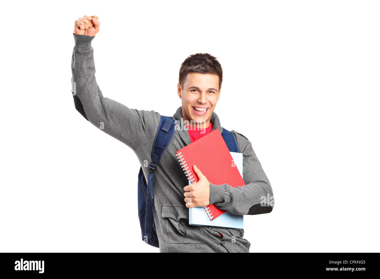 A happy student holding books and gesturing isolated on white ...