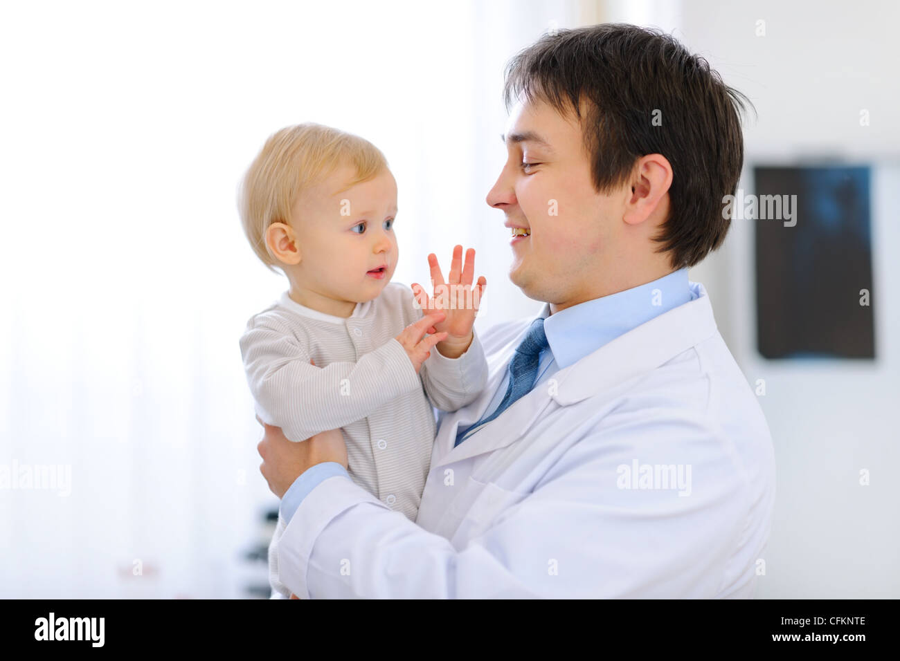 Portrait of pediatrician with baby on hands Stock Photo - Alamy