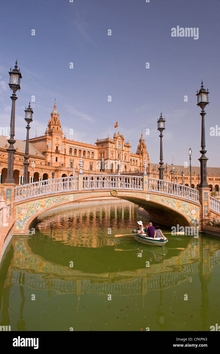 Tourists rowing in a boat at Plaza de Espana in Seville, Spain Stock ...