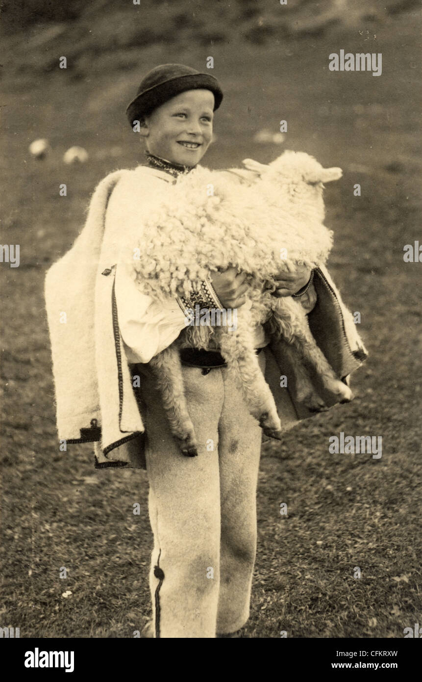 Young Shepherd Boy Carrying a Baby Lamb Stock Photo - Alamy