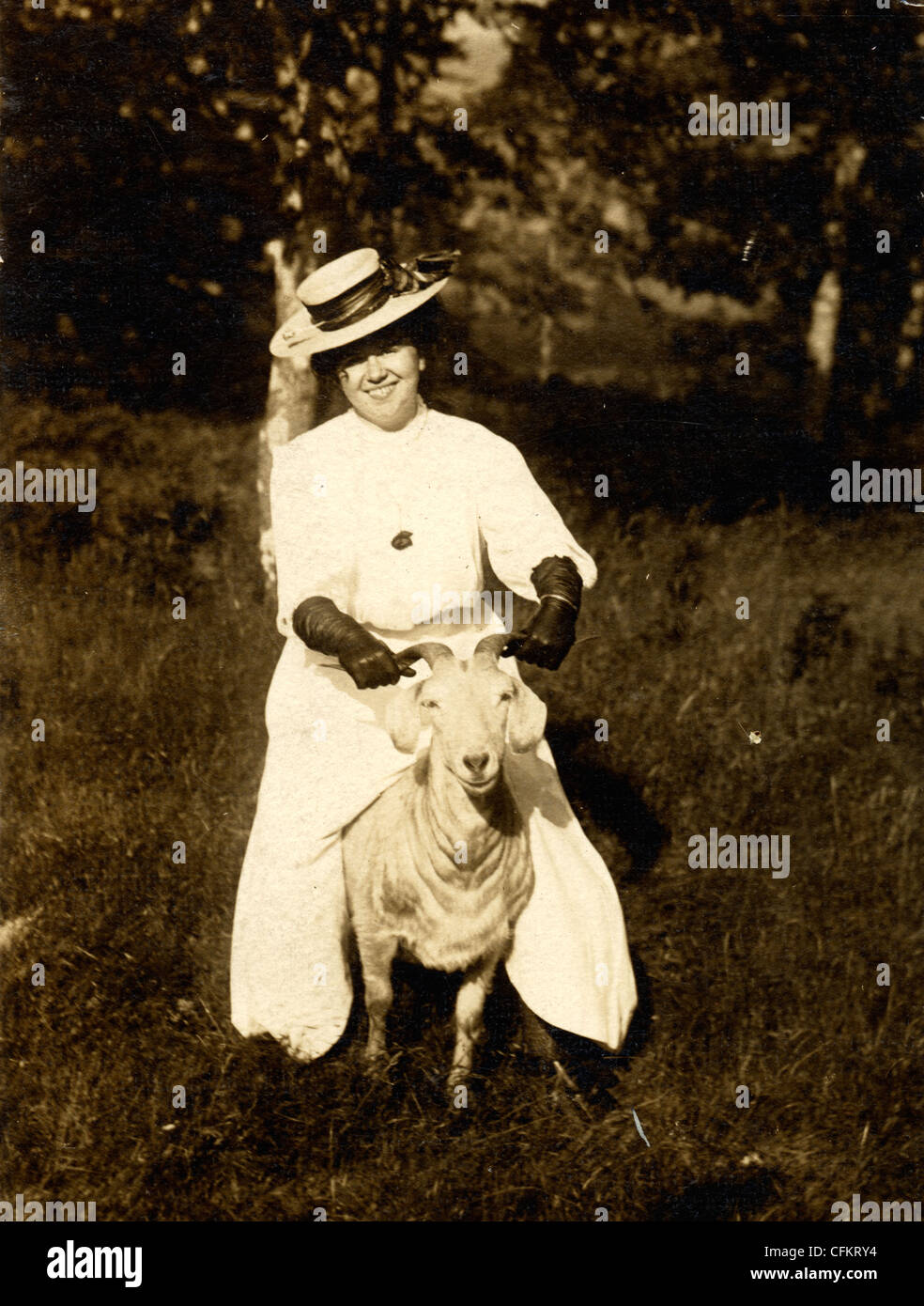 Large Woman Riding a Small Goat Stock Photo - Alamy