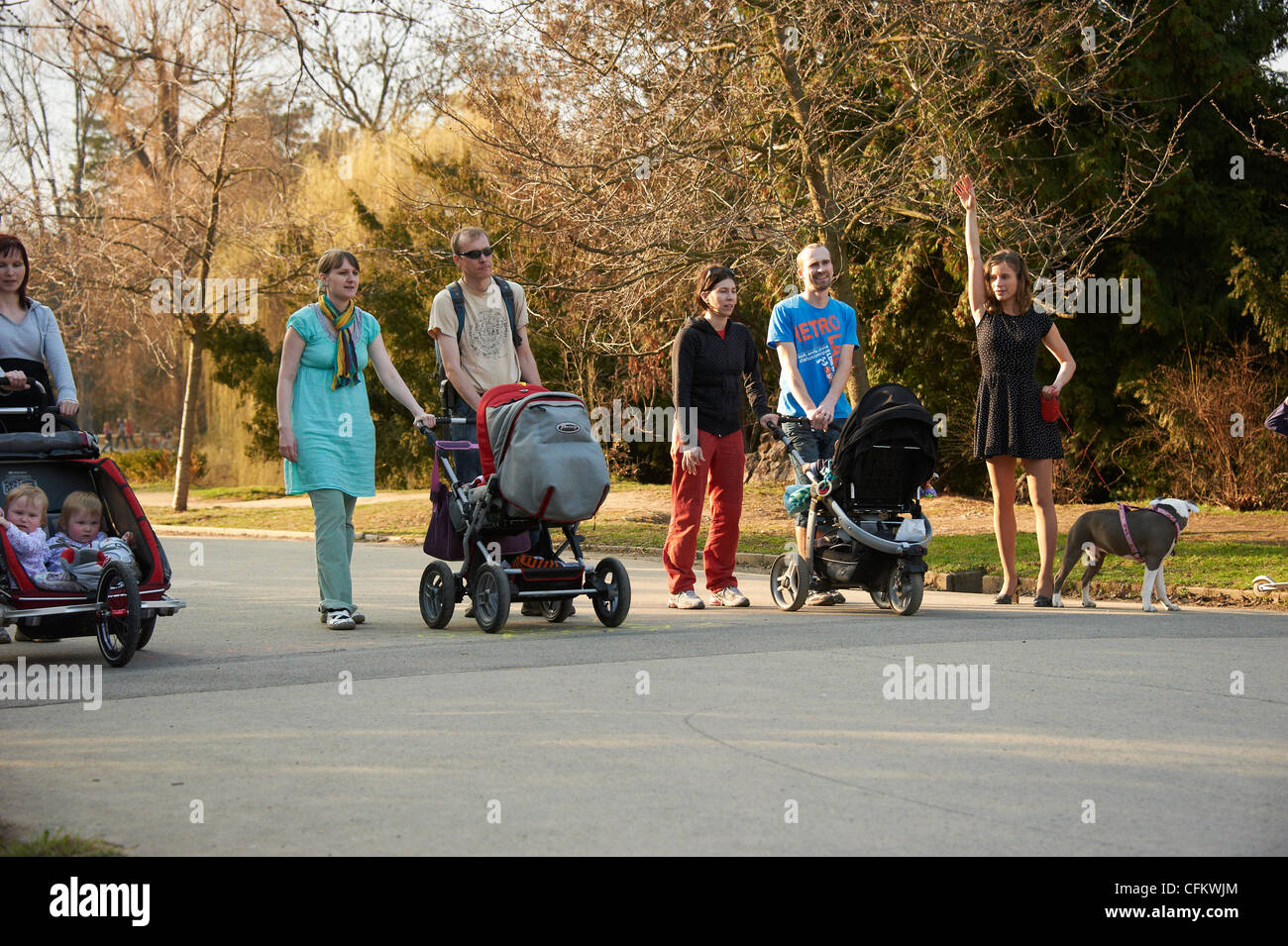 Parents running with baby in stroller in park Stock Photo - Alamy