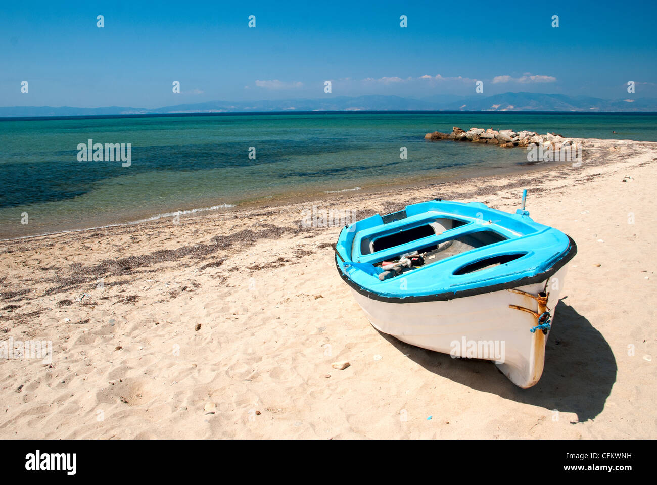 Sea shore landscape with a small boat on the sand Stock Photo - Alamy