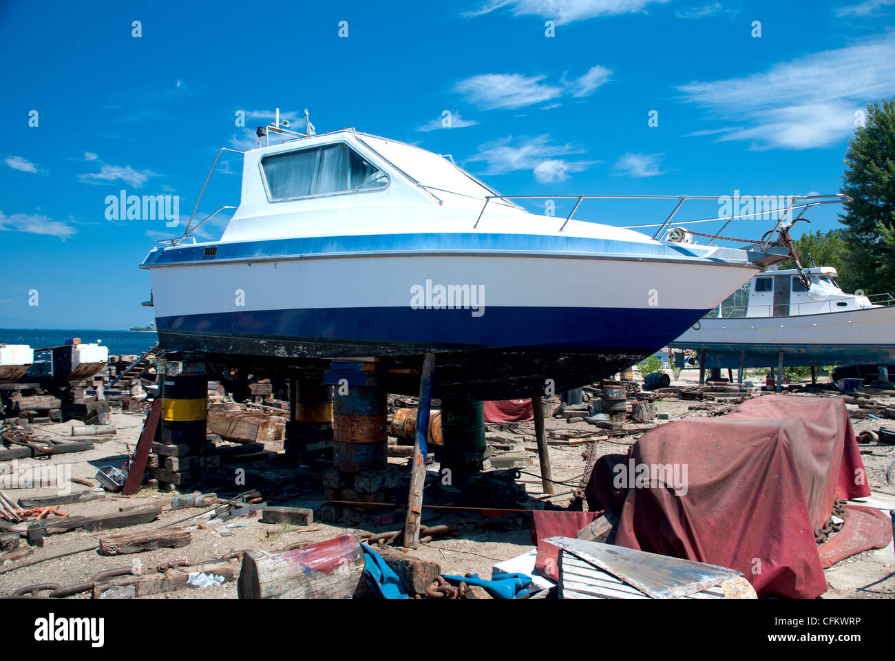Boat on shore in a shipyard Stock Photo - Alamy
