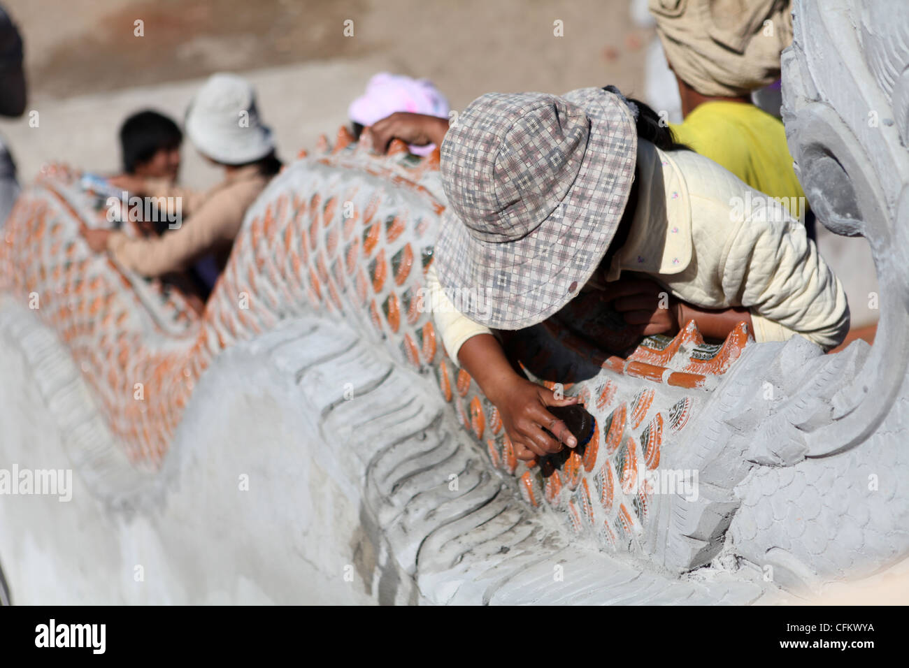 Workers building and cleaning a new Buddhist temple in Northern ...