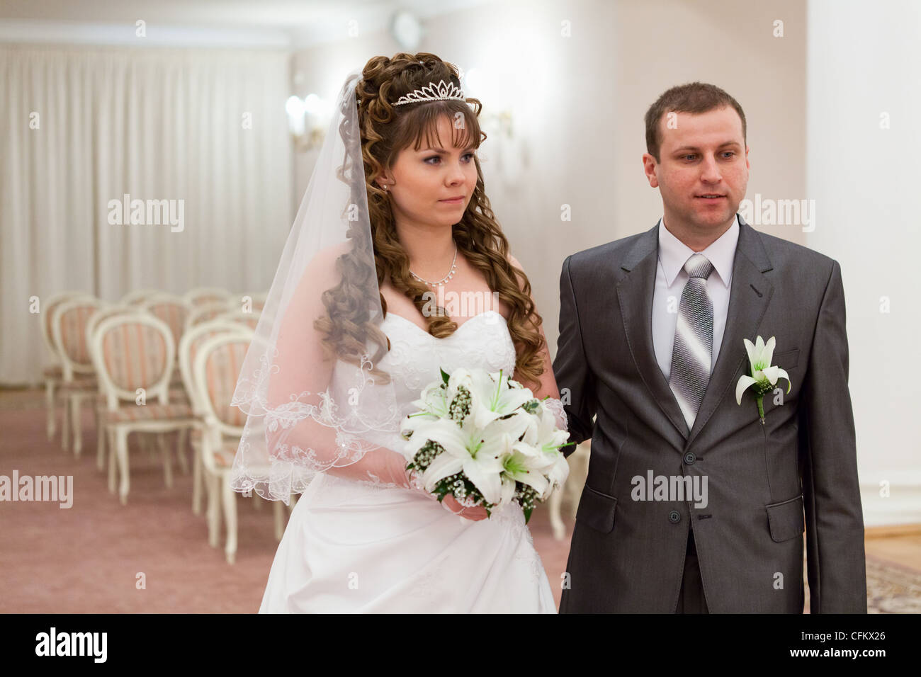 Young wedding Caucasian Russian couple. Bride standing near groom at ...