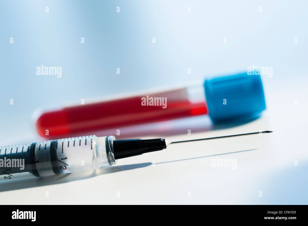 Studio shot of blood sample and syringe Stock Photo - Alamy