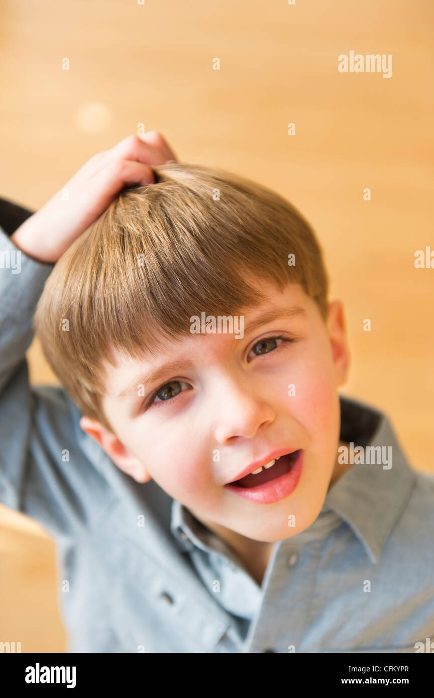 USA, New Jersey, Jersey City, Portrait of boy (4-5) scratching head ...