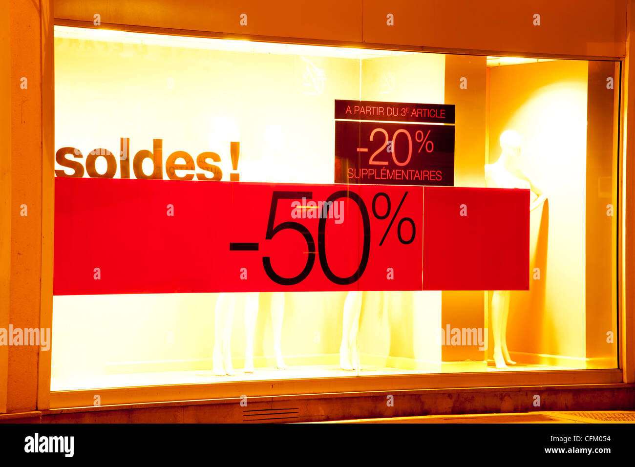 Seasonal sales sign on the window of French clothing store Stock Photo ...