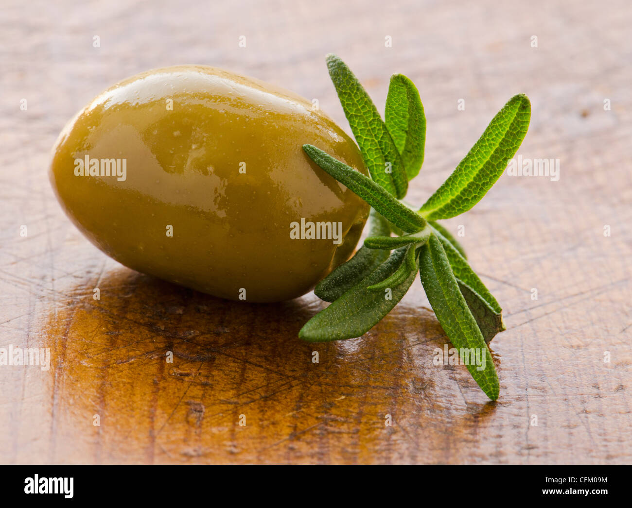 Close-up of green olive with rosemary, studio shot Stock Photo - Alamy