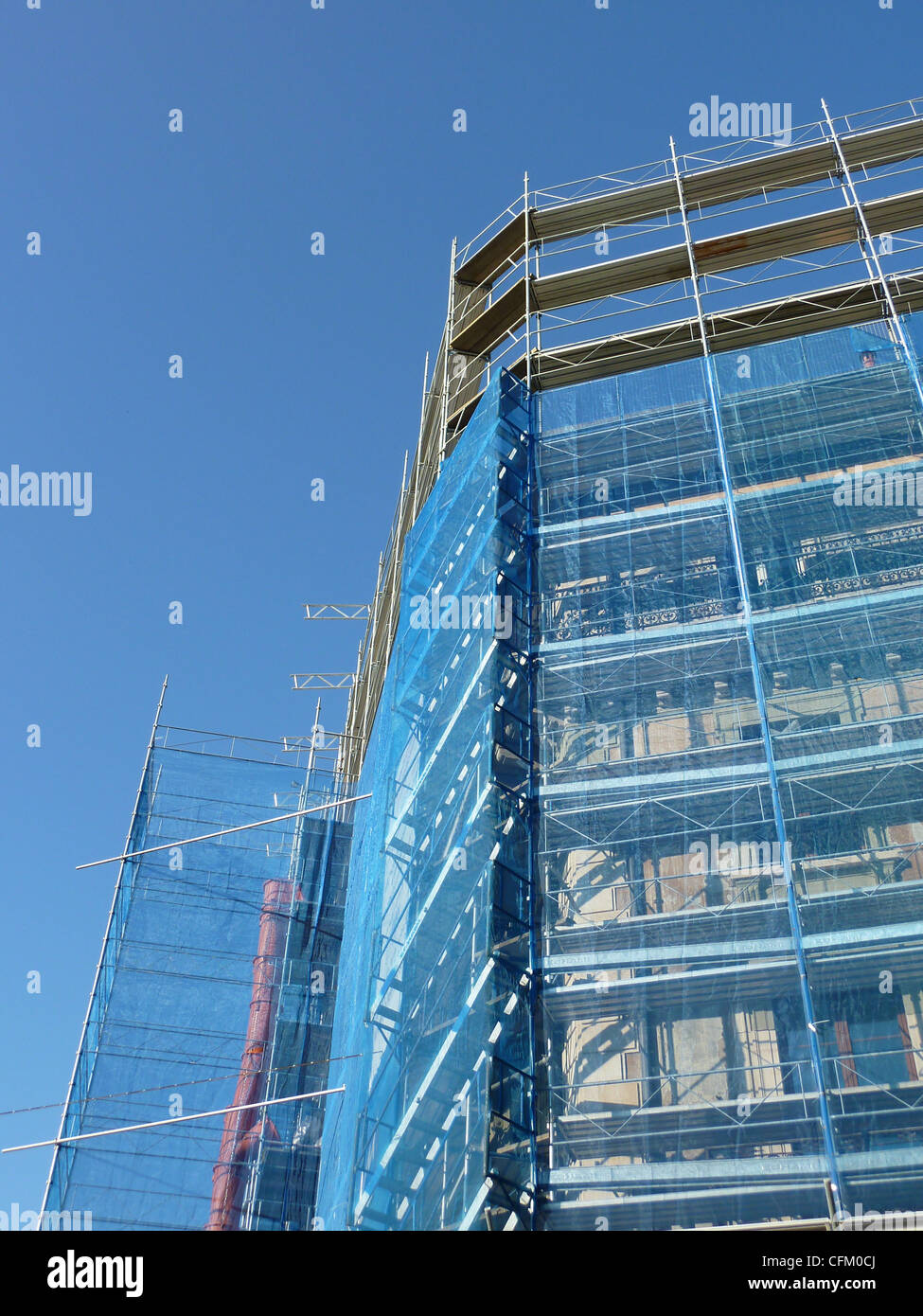 Side of a scaffolding on a building by beautiful blue day Stock Photo ...
