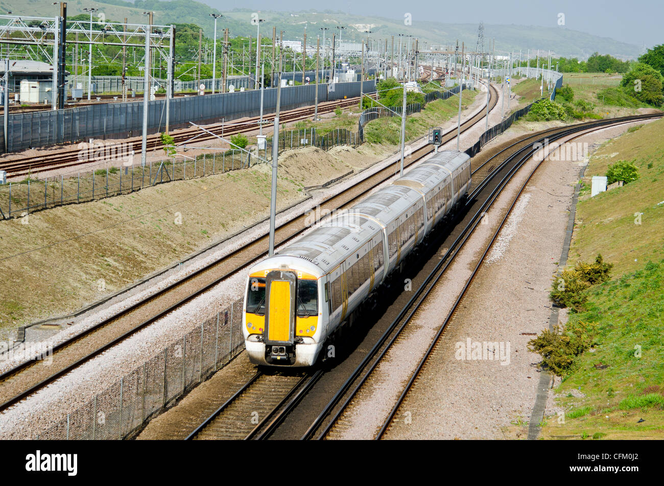 UK commuter train passing the Channel Tunnel terminal at Folkestone and ...