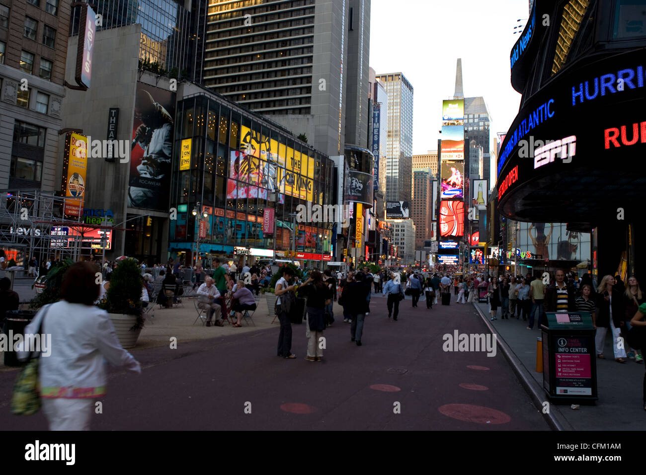 The tall buildings and adverts in Time Square with crowds of people ...