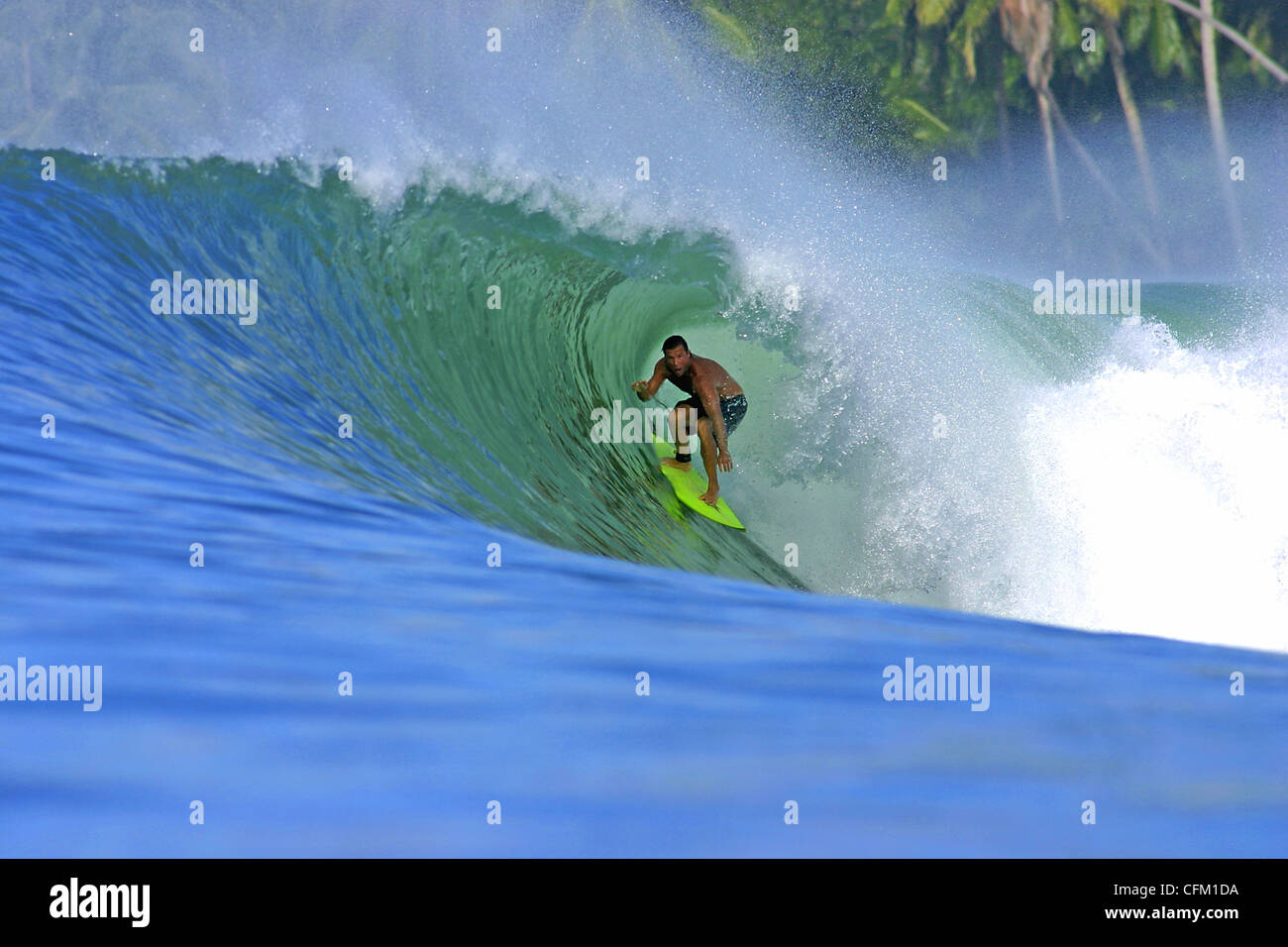 Surfing deep in the tube on a wave. Lagundri Bay, Nias, Sumatra ...