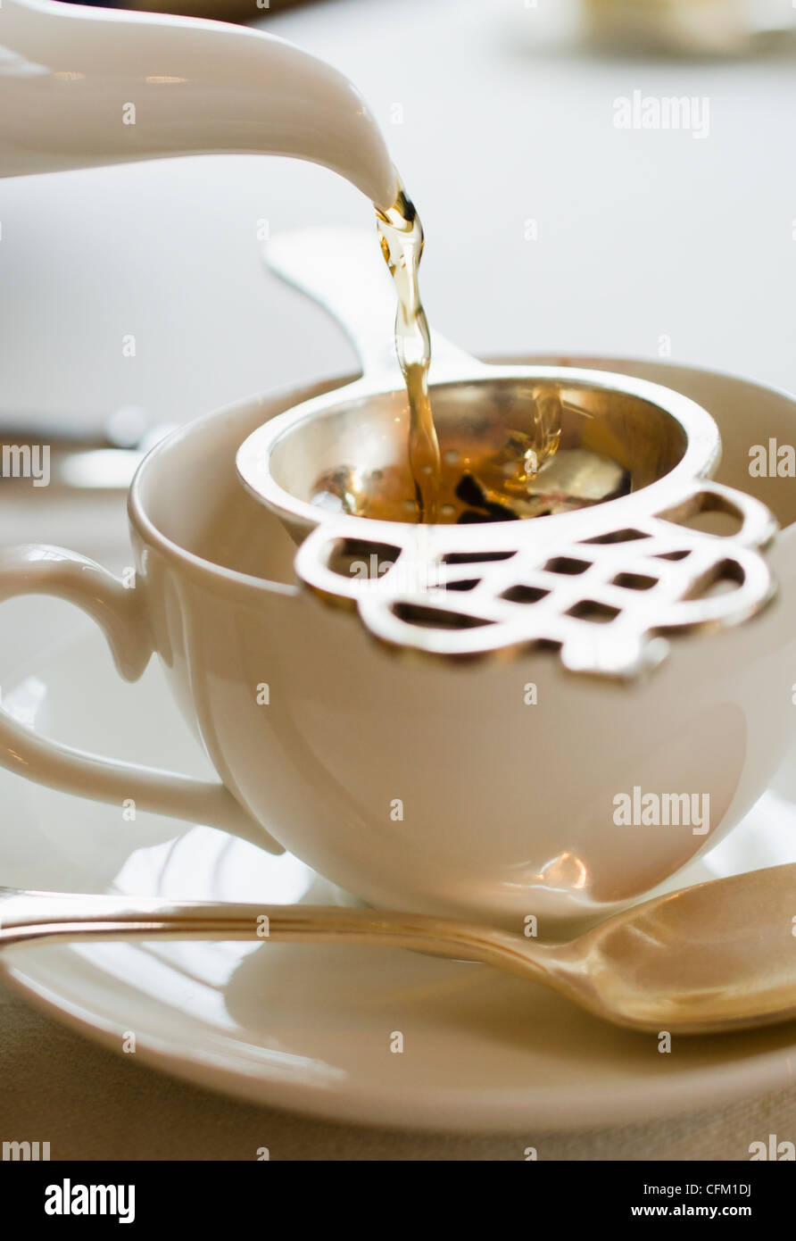 Close-up of water falling into tea cup Stock Photo - Alamy