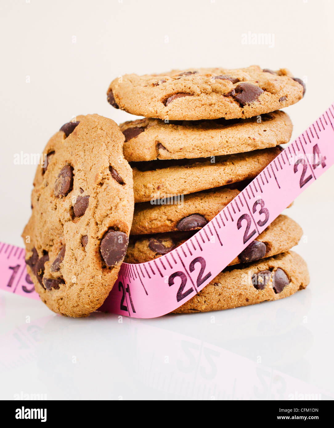Stack of chocolate chip cookies with measure tape Stock Photo - Alamy