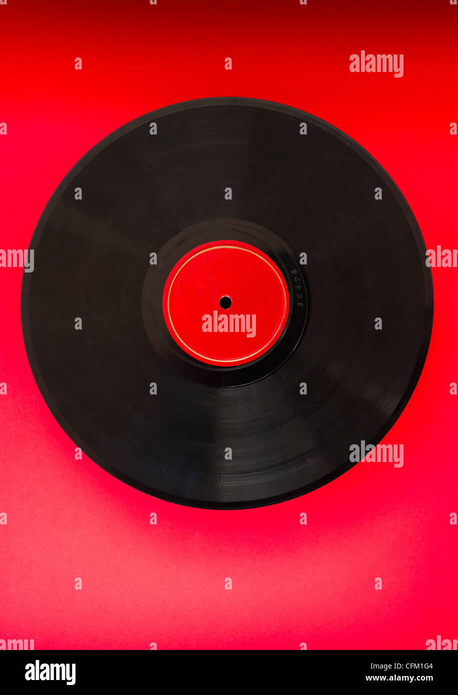 Vinyl record in on red background, studio shot Stock Photo - Alamy