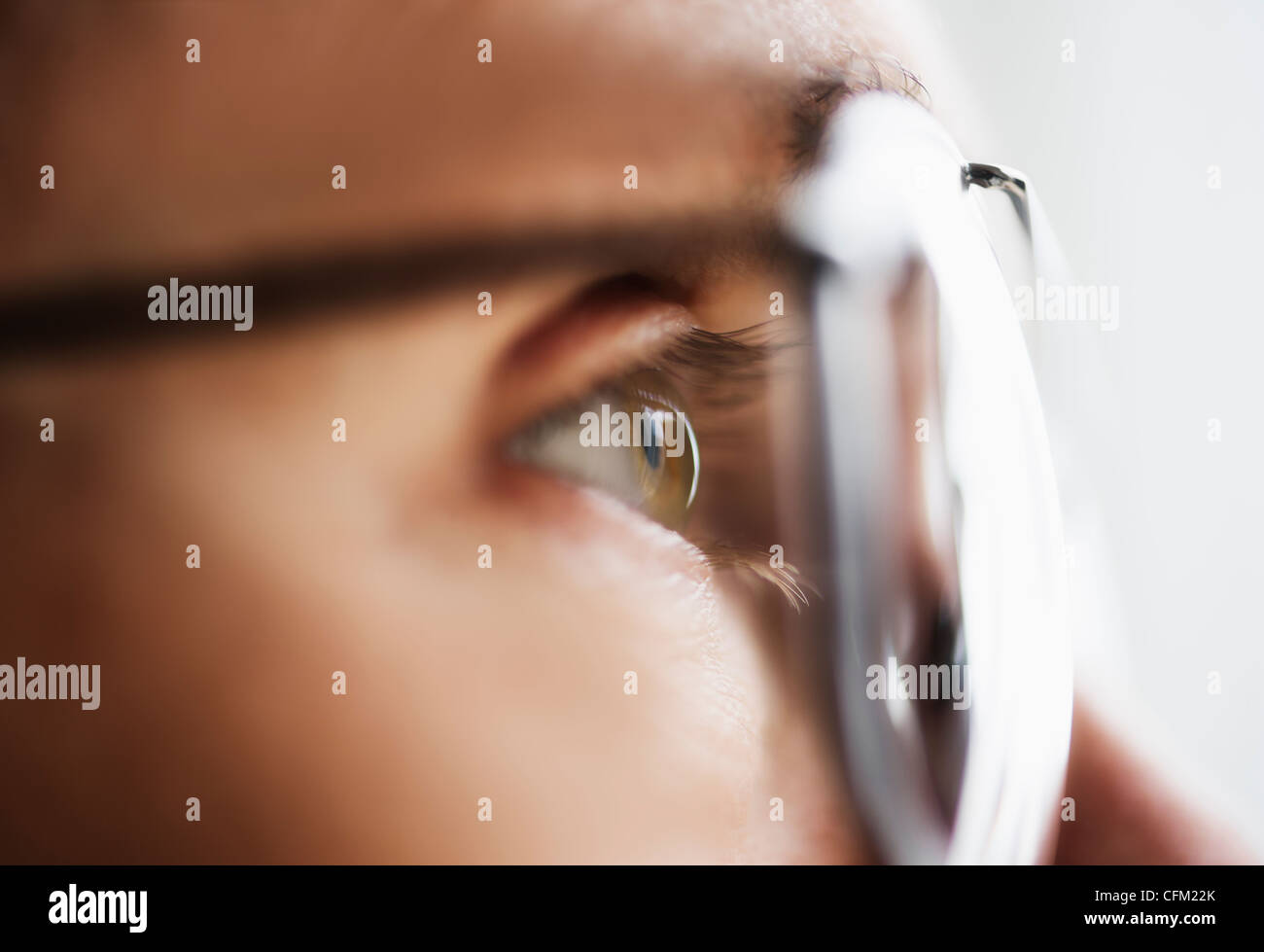 Close up of men's eye looking through glasses Stock Photo - Alamy