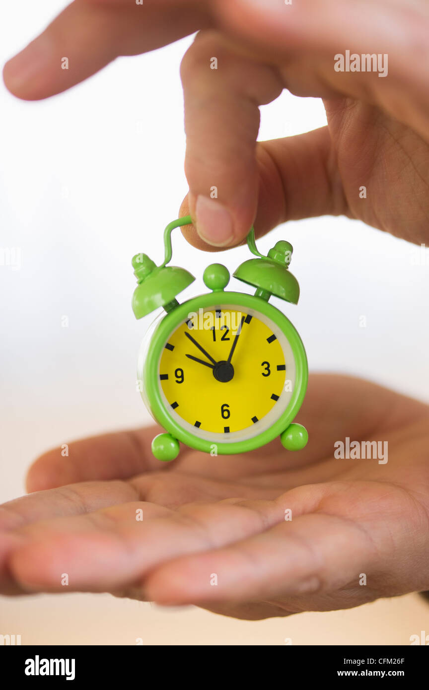 Alarm clock in hand hi-res stock photography and images - Alamy