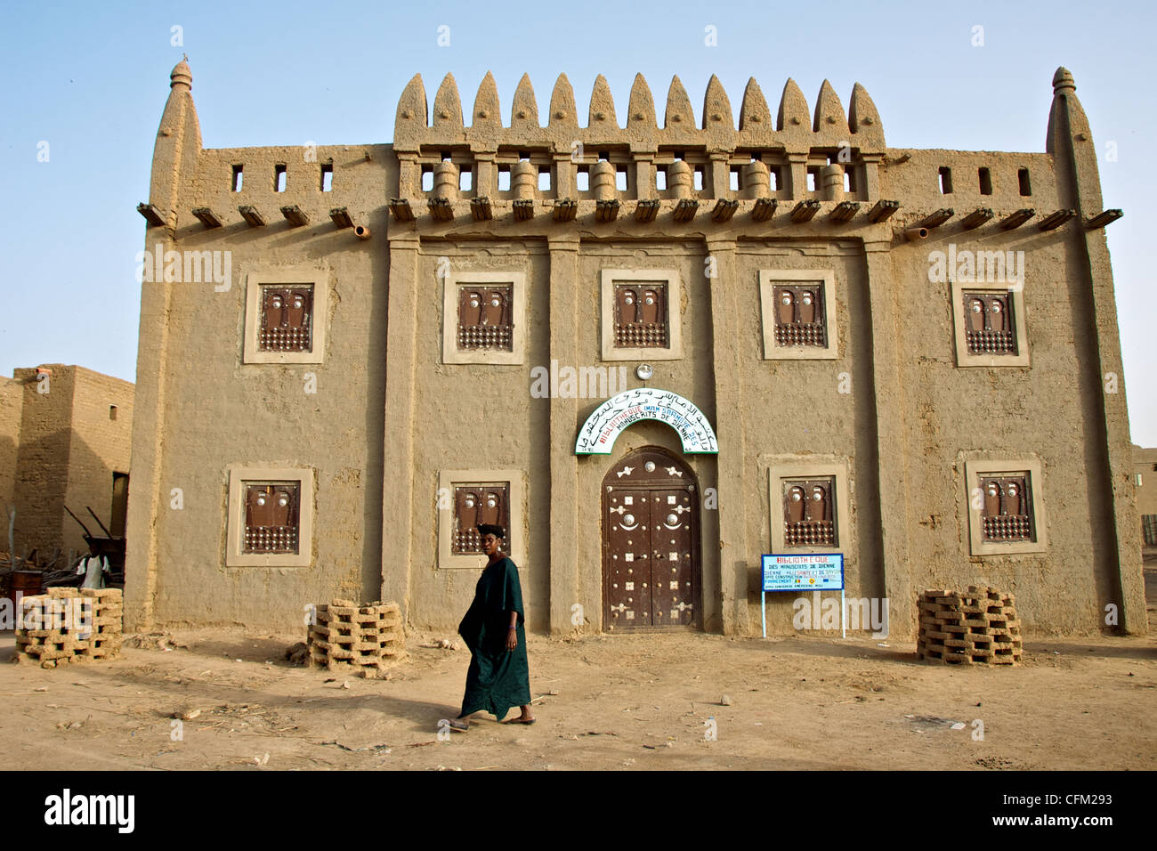 A woman walks by a library in Djenne, Mali Stock Photo - Alamy