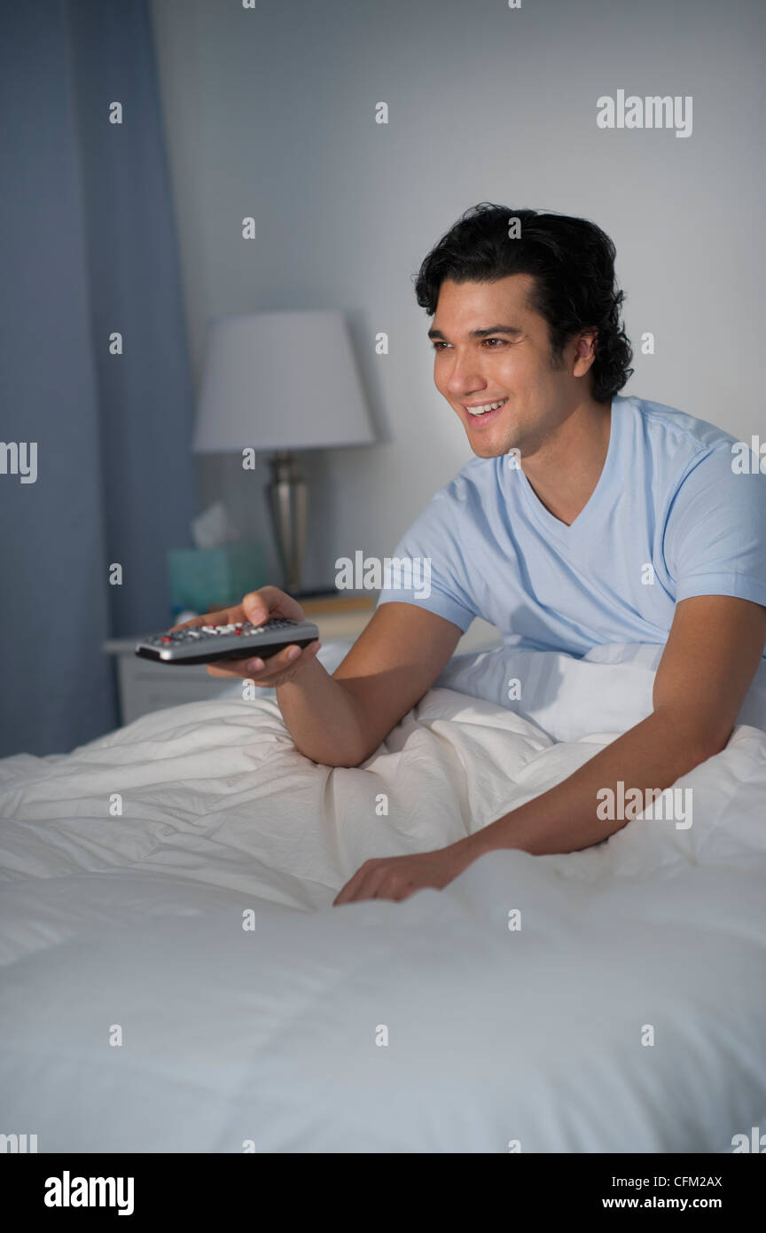 Man watching television in bed hi-res stock photography and images - Alamy