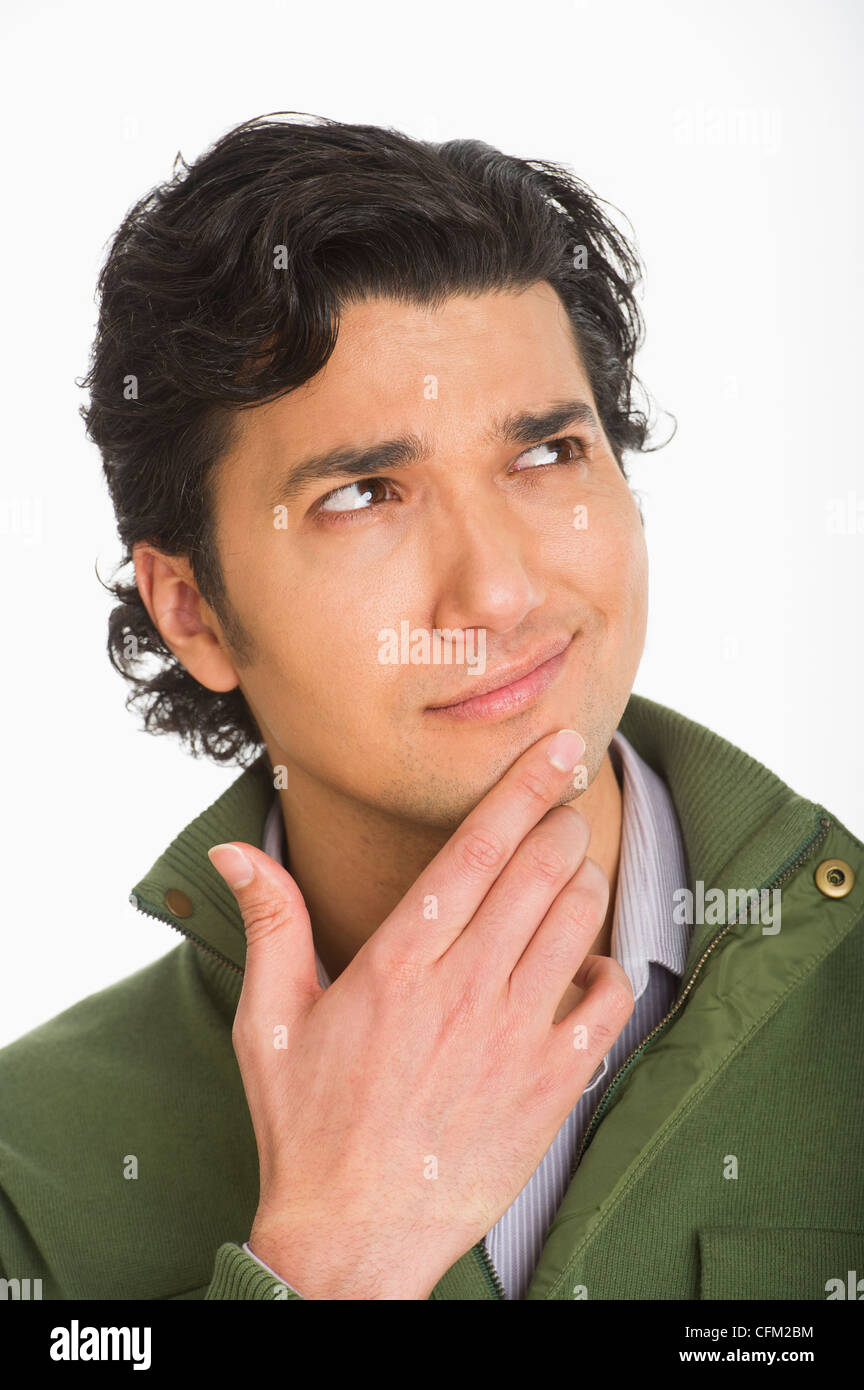 Studio shot of young man looking confused Stock Photo - Alamy