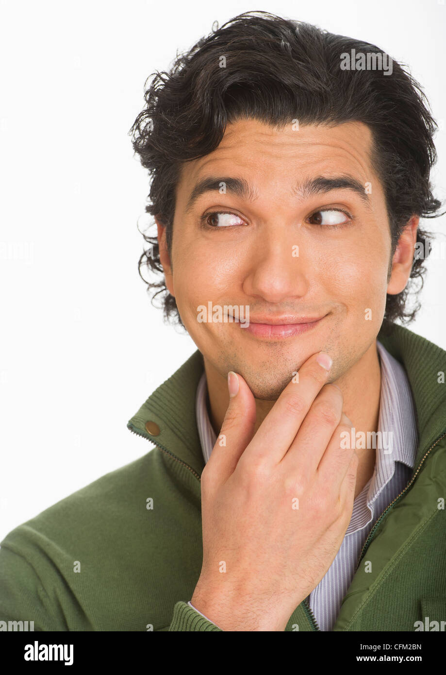 Studio shot of young man looking surprised and happy Stock Photo - Alamy