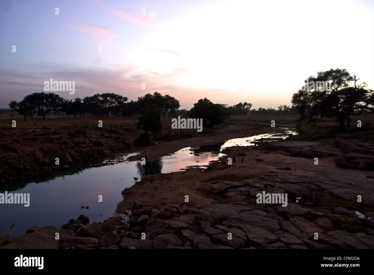 A sunset reflects on a river in Dogon, Mali Stock Photo - Alamy