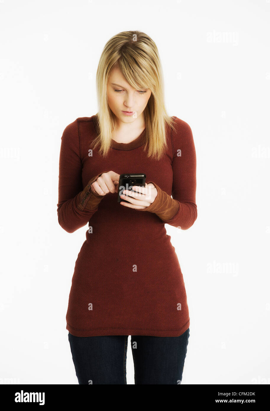 Studio shot of woman text messaging Stock Photo - Alamy