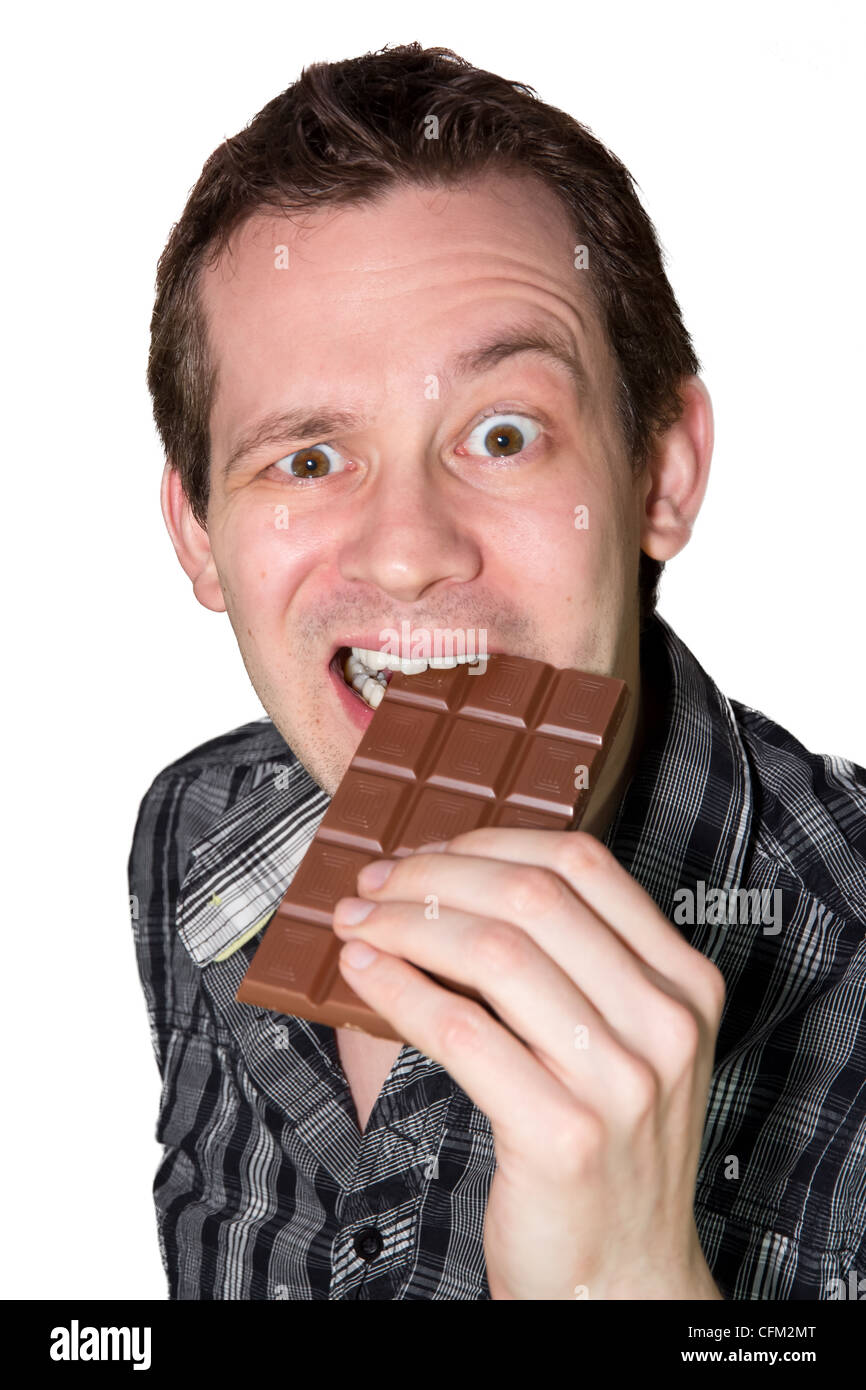 Picture of a man crushing his teeths on a mighty hard chocolate Stock ...