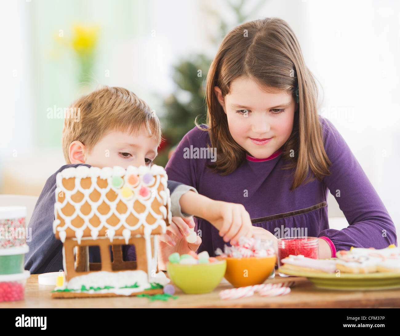 Happy children preparing gingerbread on hi-res stock photography and ...