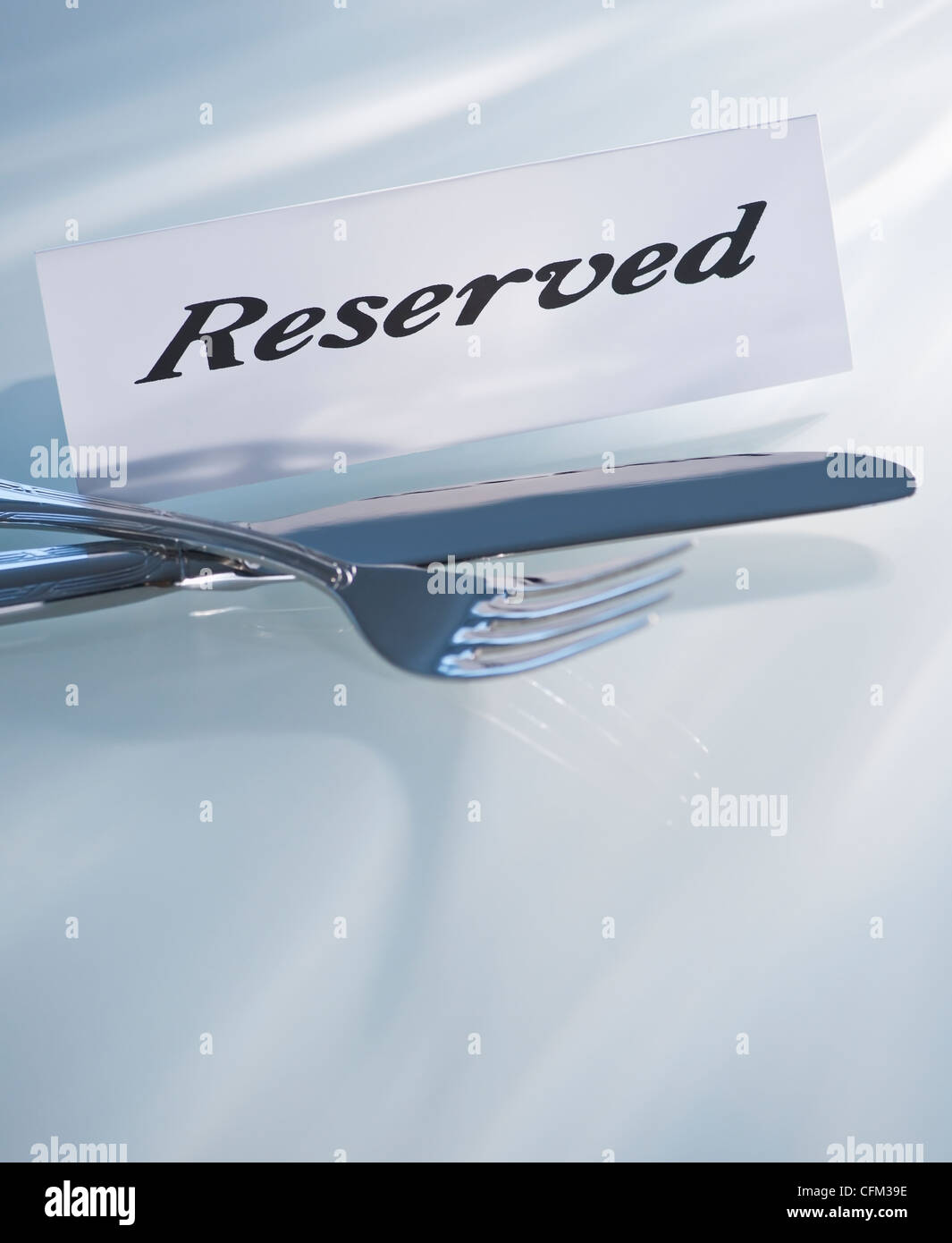 Studio shot of silverware and Reserved sign Stock Photo - Alamy