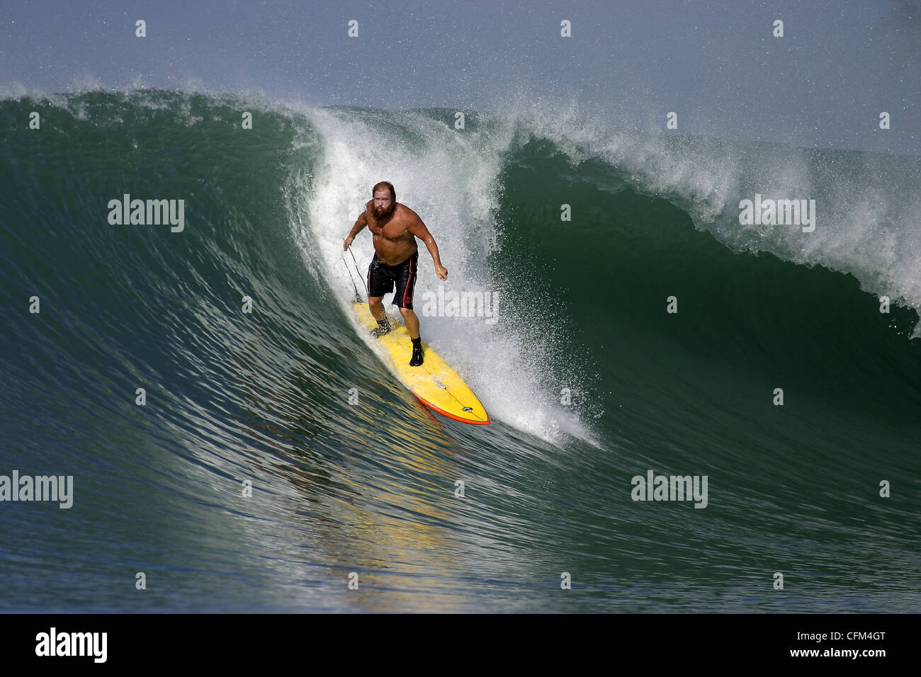 Large man surfing a wave. Lagundri Bay, Nias, Sumatra, Indonesia ...