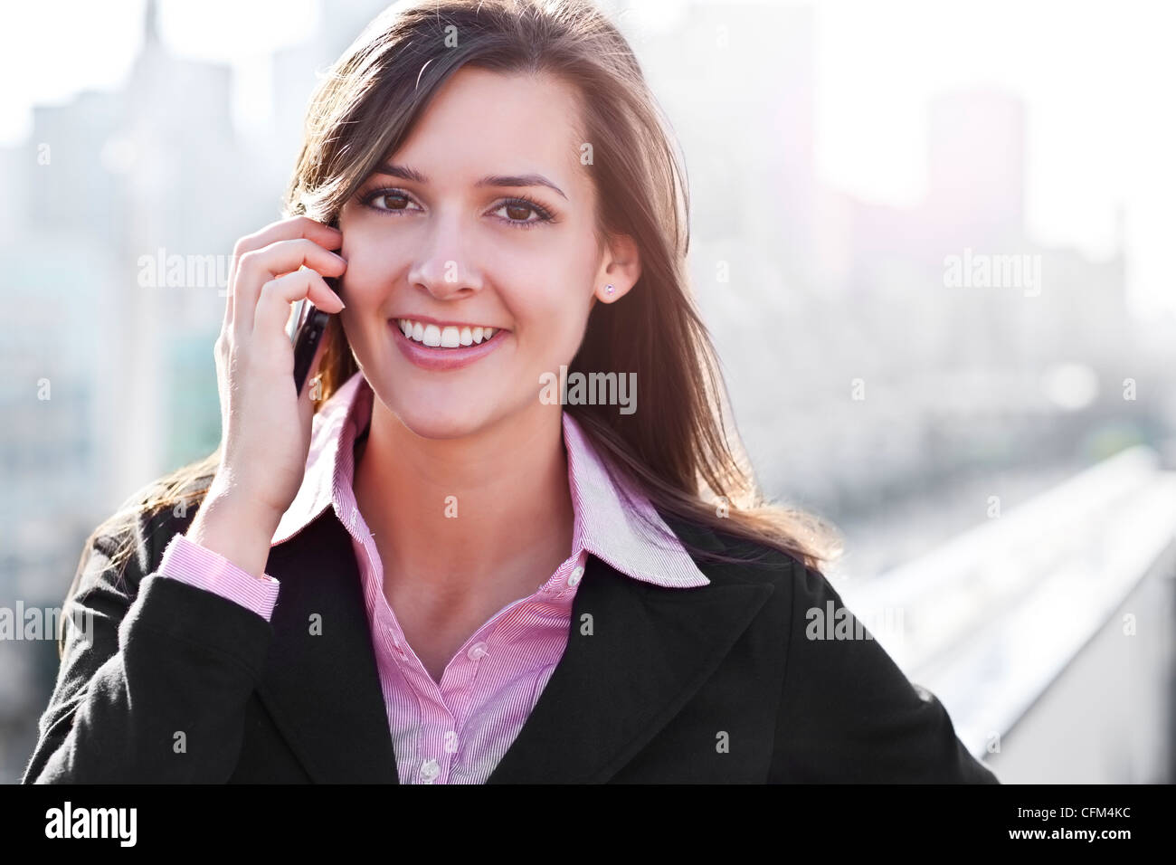 USA, Seattle, Smiling young businesswoman talking via mobile Stock ...