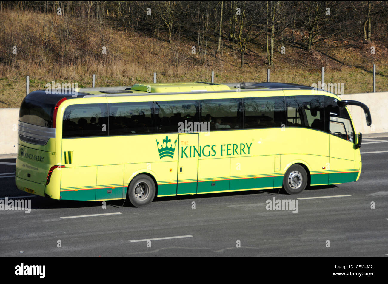 Side view of Kings Ferry coach bus travel along M25 motorway Essex ...