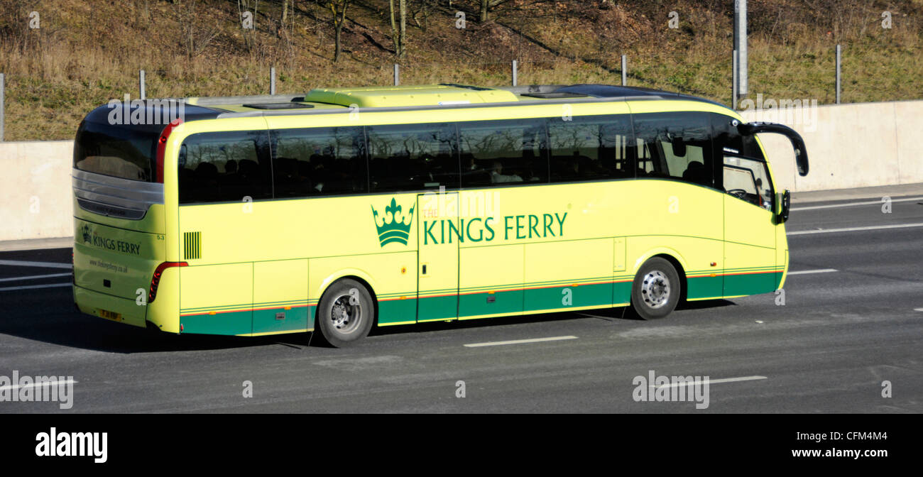 Side view of Kings Ferry coach bus travel along M25 motorway Essex ...