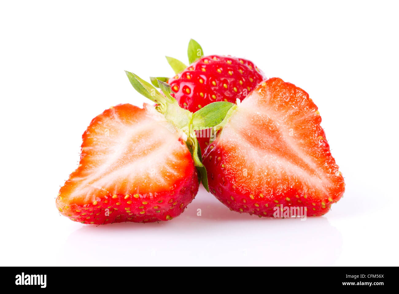 Two half strawberries in closeup over white background Stock Photo - Alamy