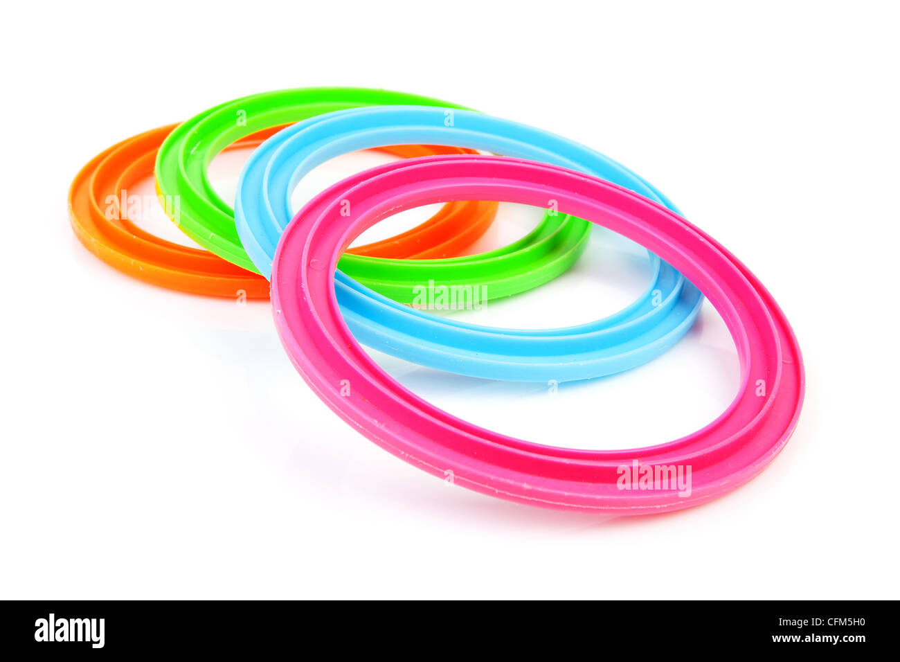 Four colorful plastic rings over white background Stock Photo - Alamy