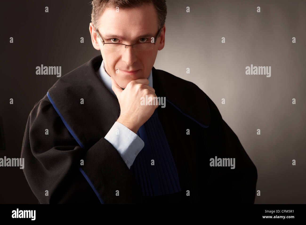 Attorney wearing classic gown thinking in court Stock Photo - Alamy