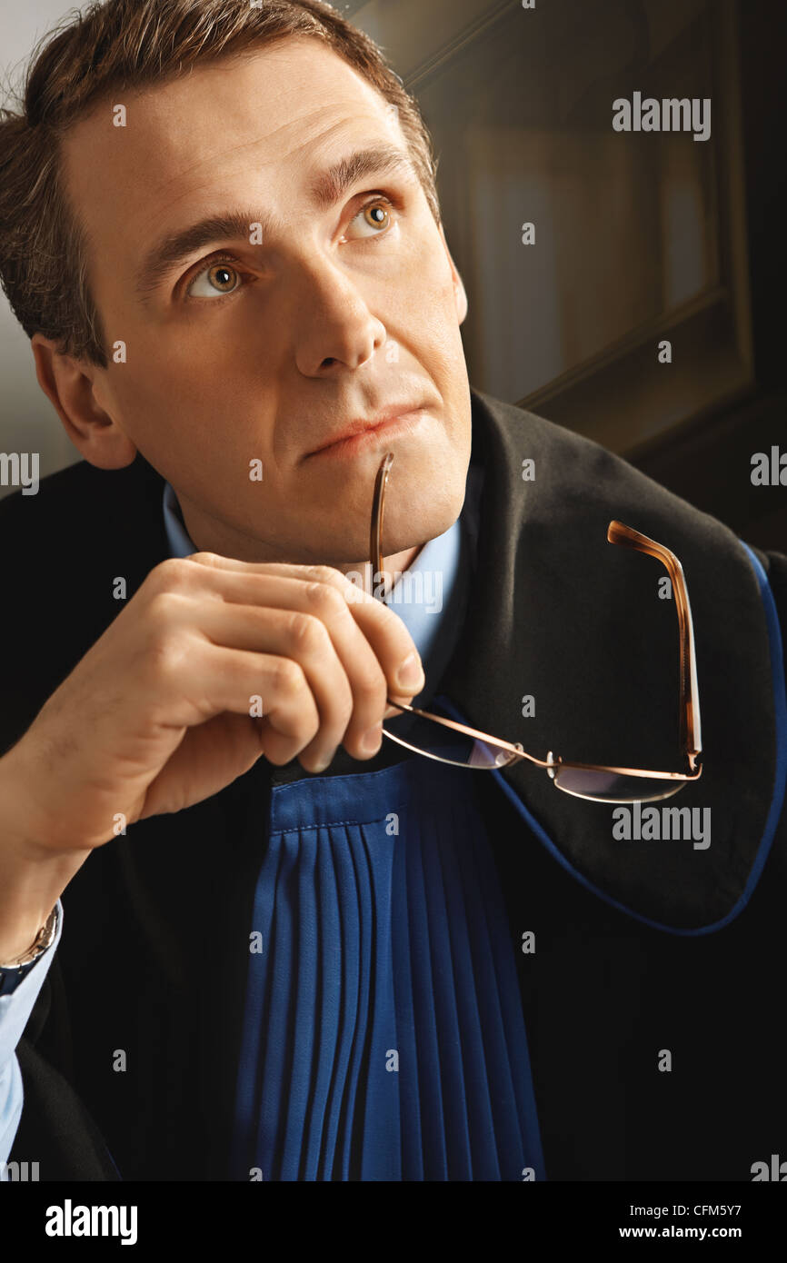 Attorney wearing classic gown thinking in court Stock Photo - Alamy