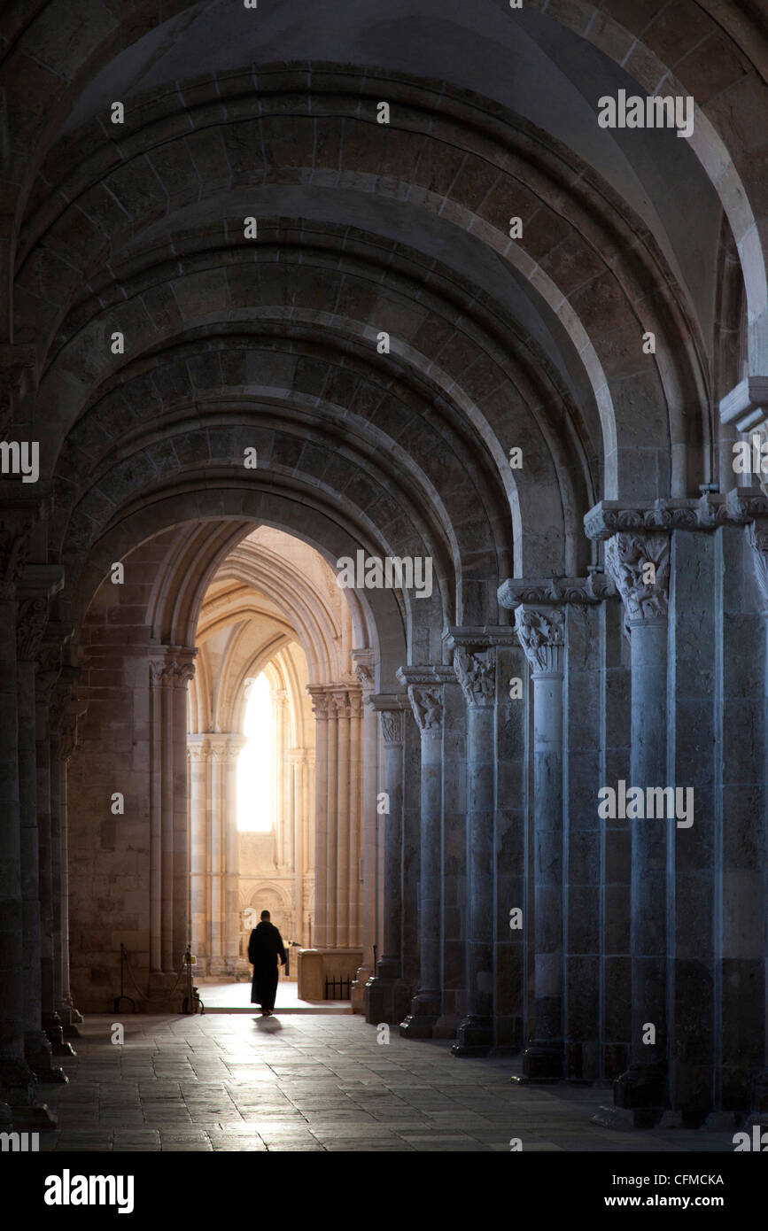 Interior north nave aisle with priest walking away, Vezelay Abbey ...