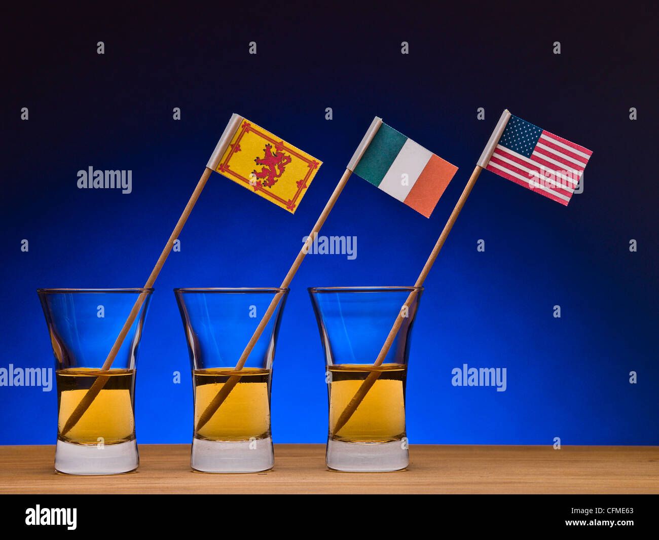 Three glasses of whisky with the flags of Scotland, Ireland and the ...