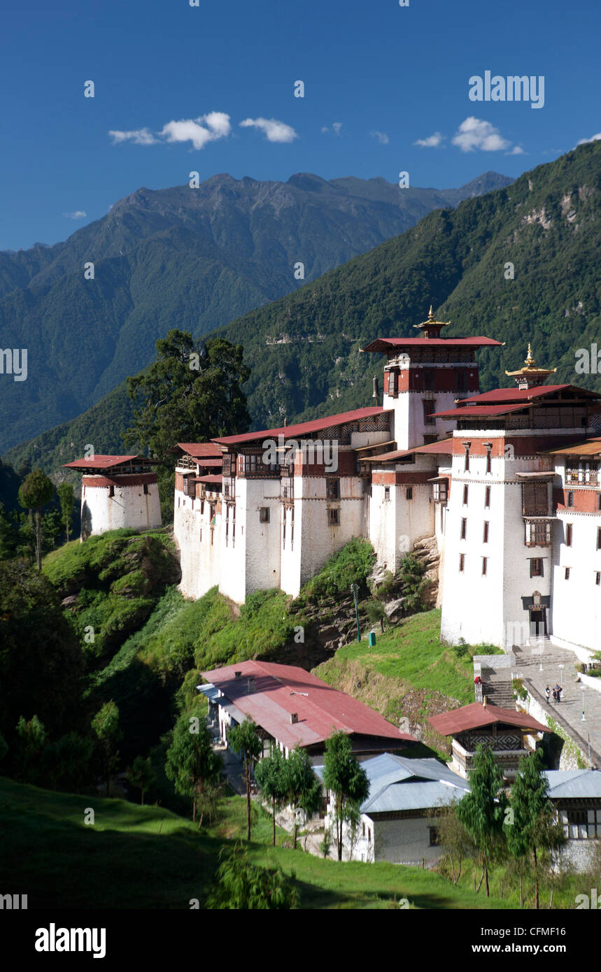 Trongsa Dzong set against tree-covered mountains, Trongsa, Bhutan ...