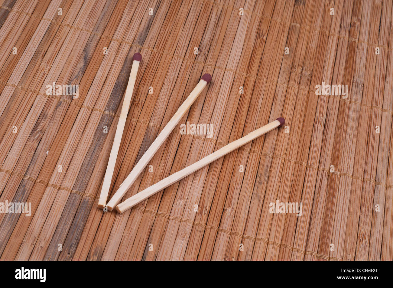 Three Matches on the bambo background Stock Photo - Alamy