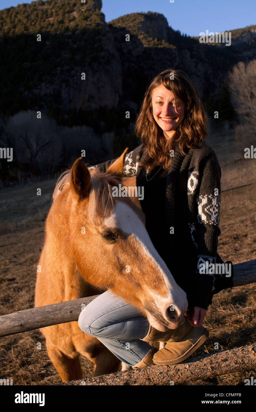 USA, Colorado, Portrait of young smiling woman with horse Stock Photo ...