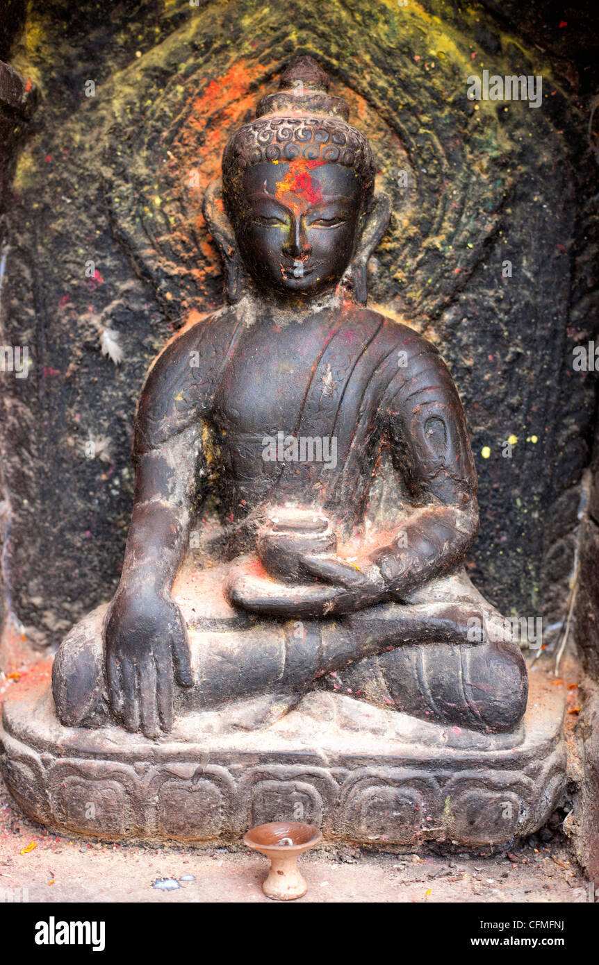 Small shrine with blessing of colourful paint and offerings of food ...