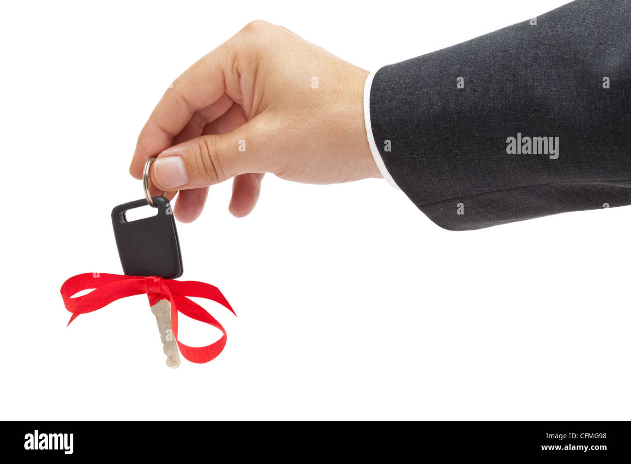 Handing over car key with red bow as a present Stock Photo - Alamy