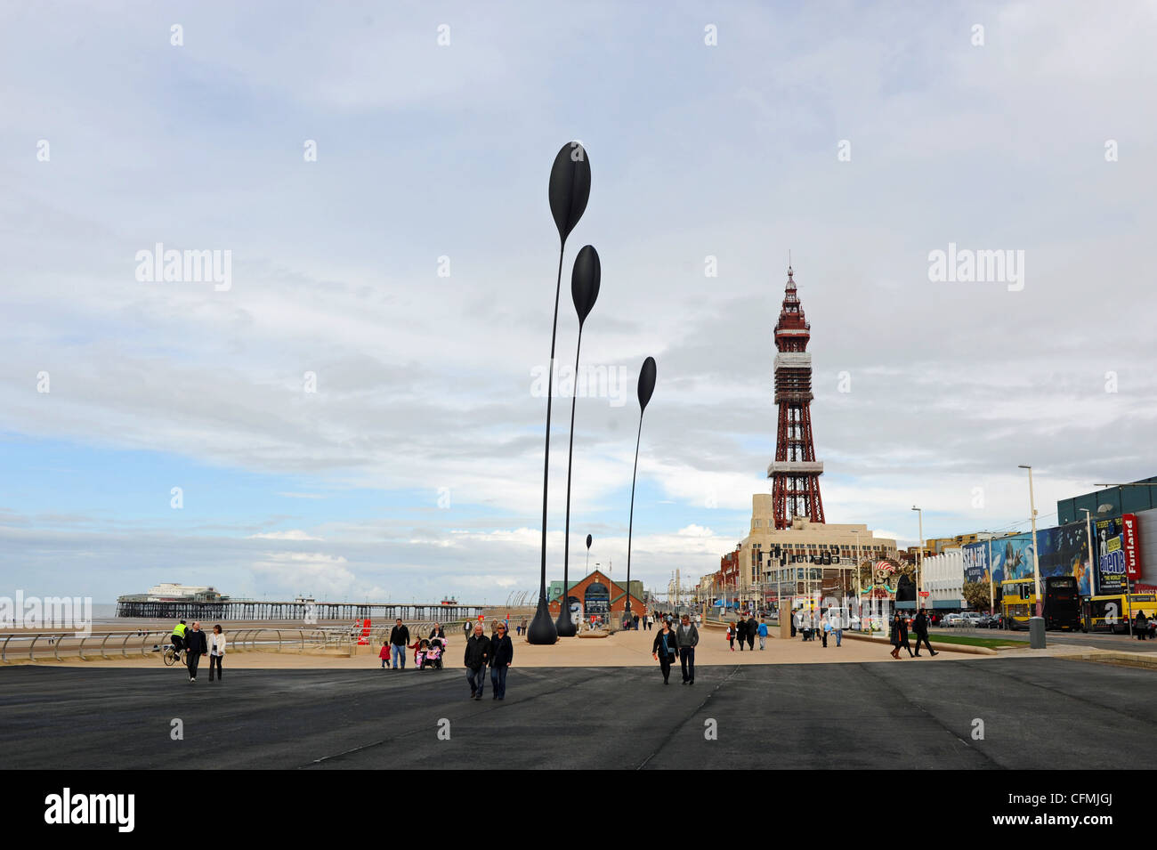 People walking on Blackpool seafront with the tower behind Lancashire ...