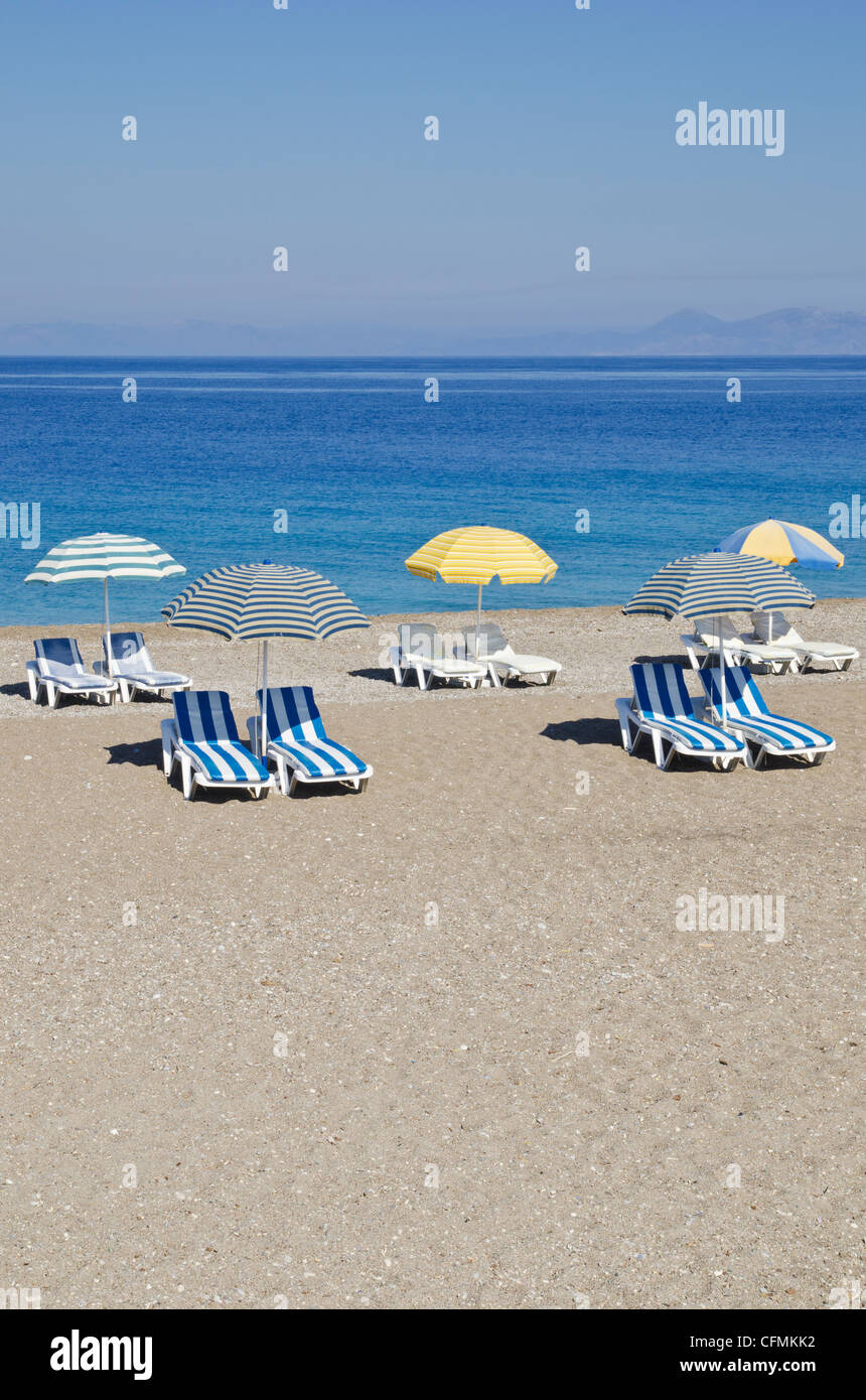 Sunloungers on an empty Greek beach on Rhodes Island, Greece Stock ...