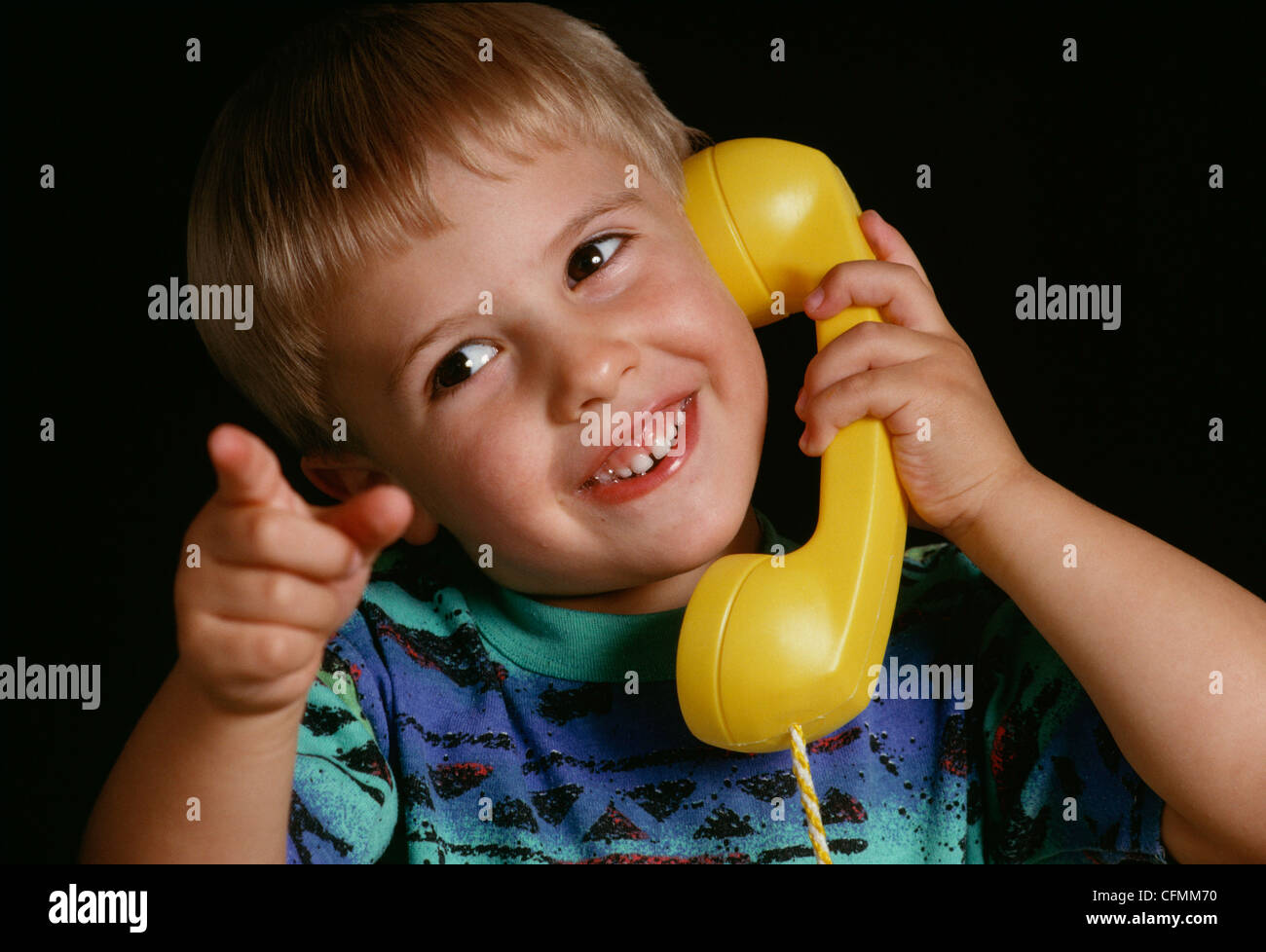 Boy talking on toy phone Stock Photo - Alamy